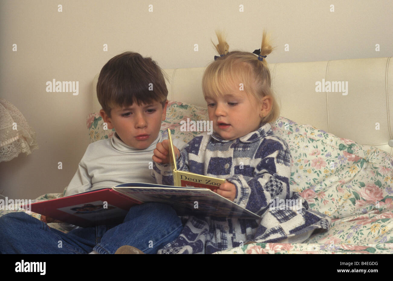 brother and sister reading a book together Stock Photo - Alamy