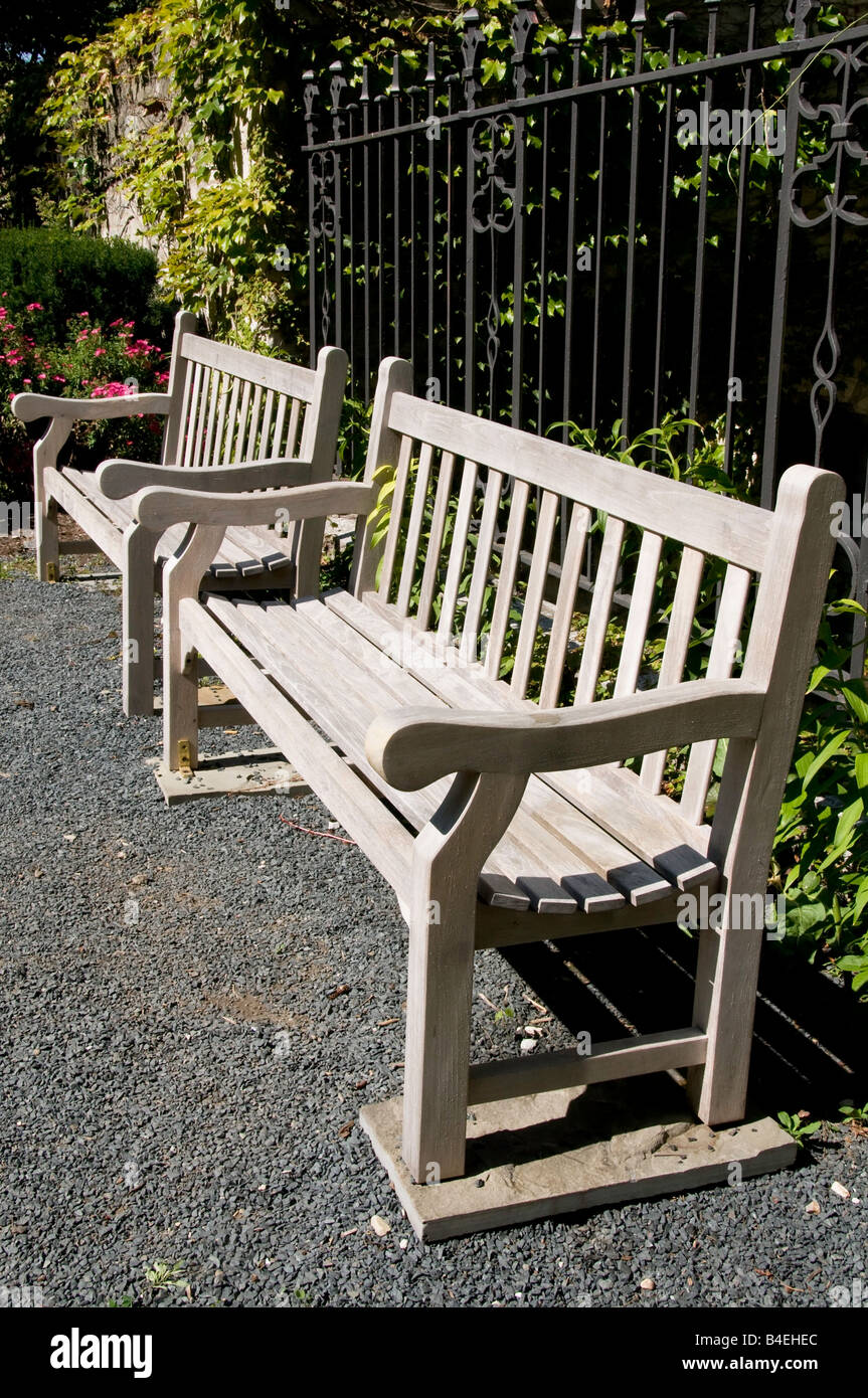 Two wooden benches in a sunny garden Stock Photo - Alamy