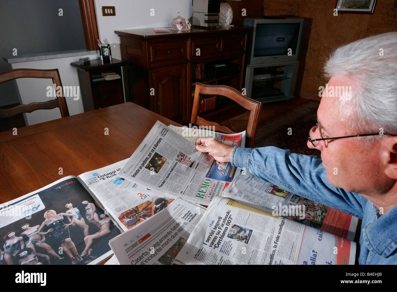 Man reading news at home Stock Photo - Alamy