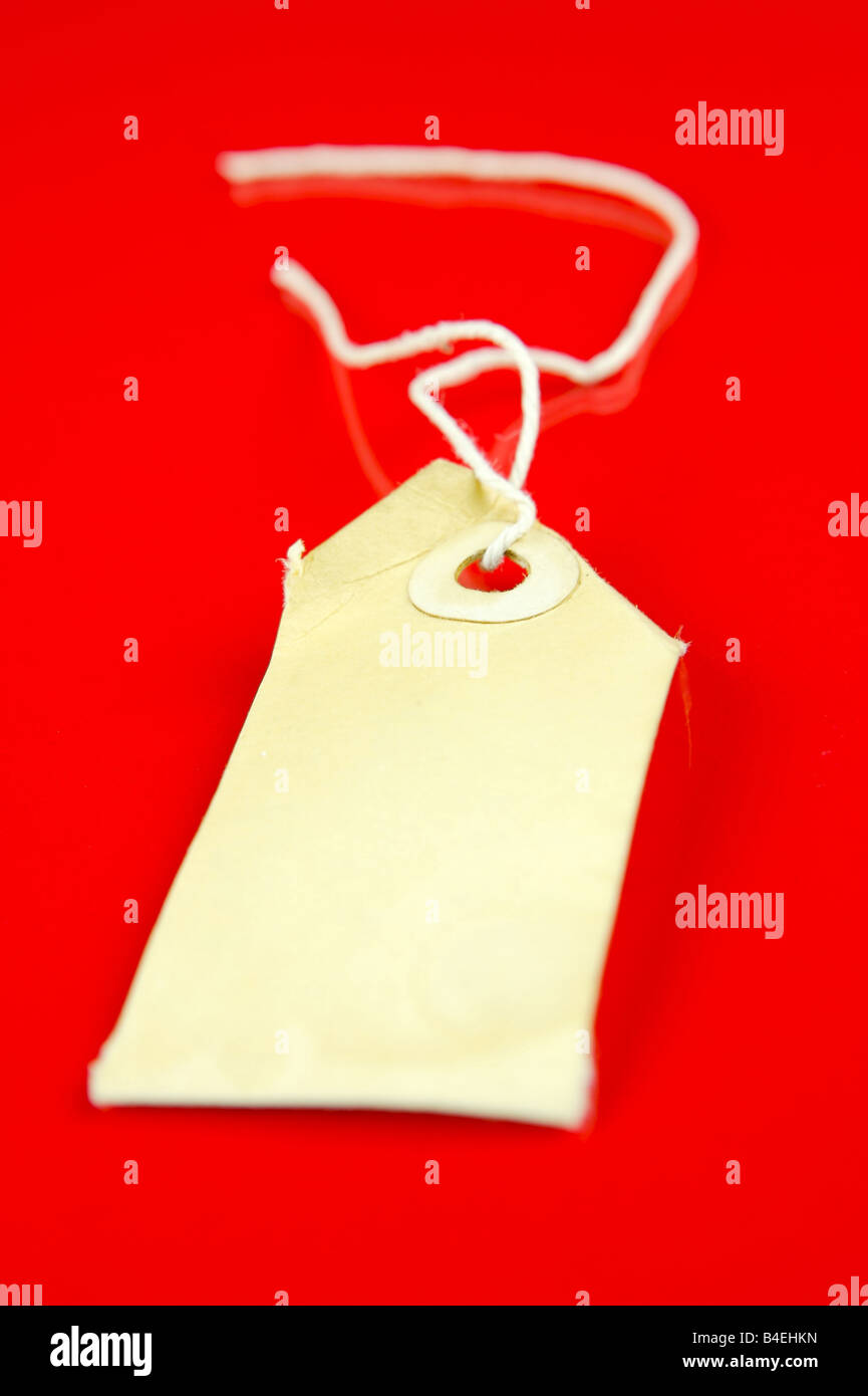 A price tag isolated against a red background Stock Photo - Alamy