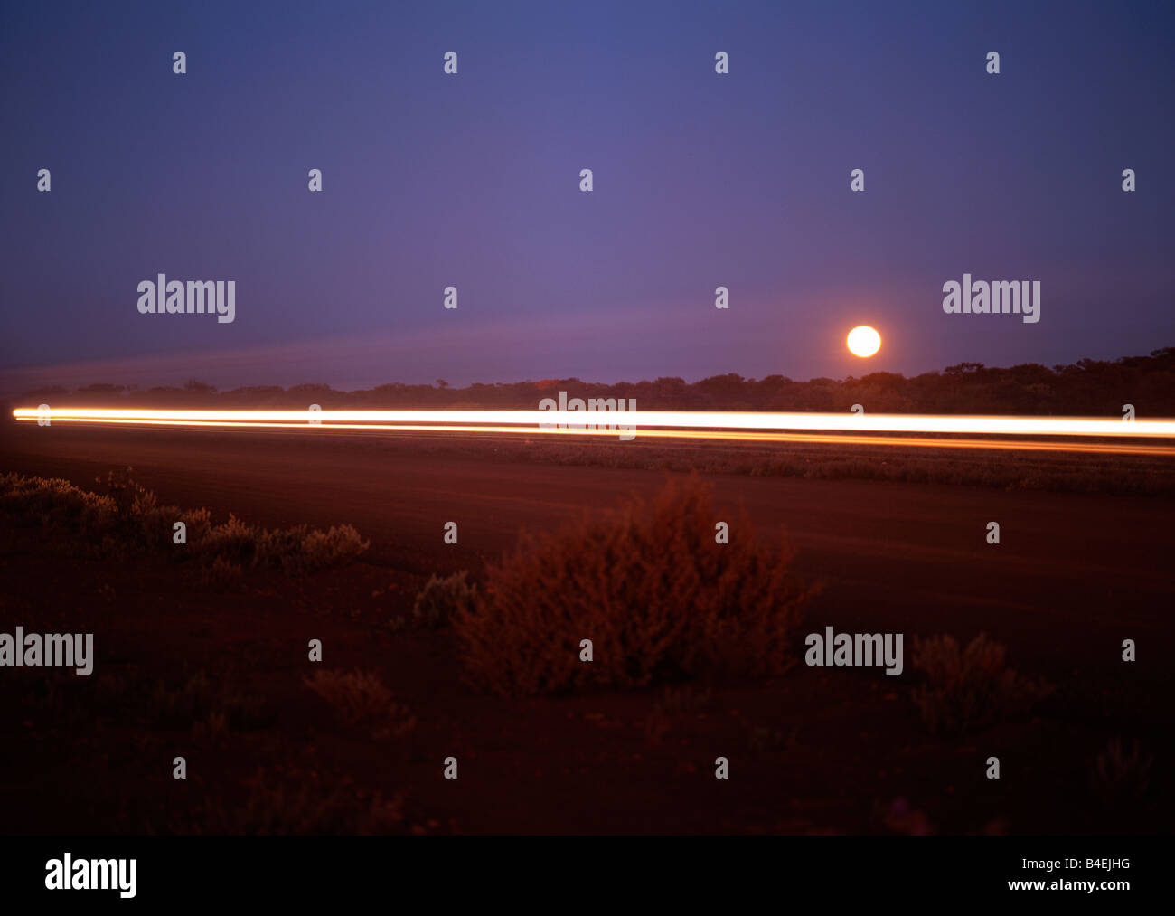 Moving Automobile Lights on Australian Outback Road Stock Photo - Alamy