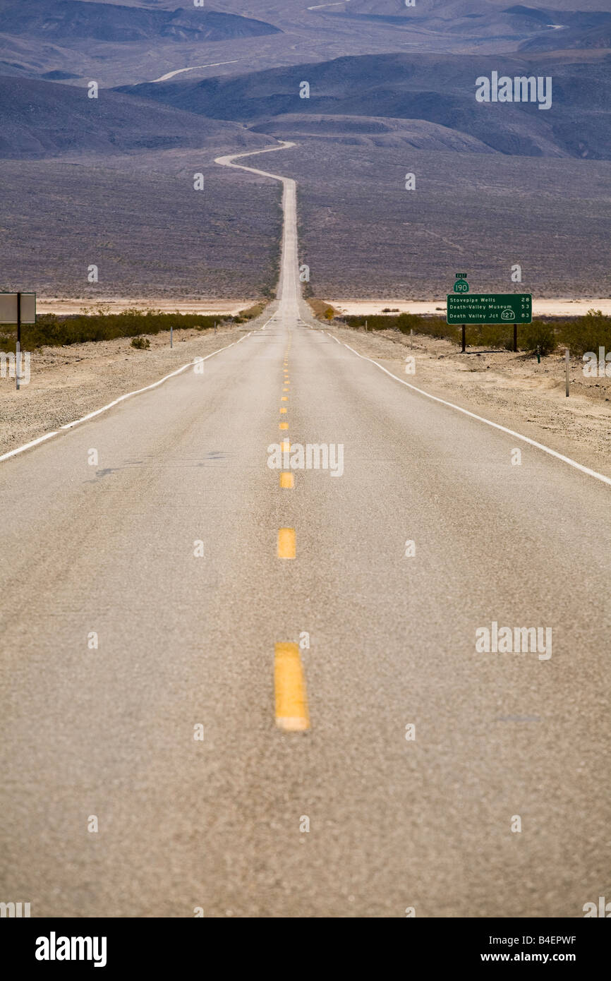 Long straight road leading to mountains out of Death Valley California ...