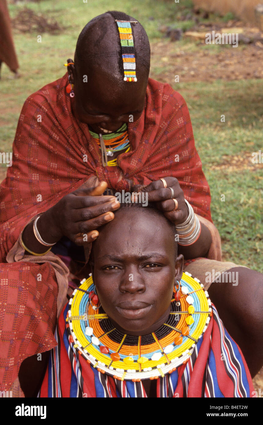 Karamojong women hairdressing in village, Karamoja, Uganda Stock Photo - Alamy