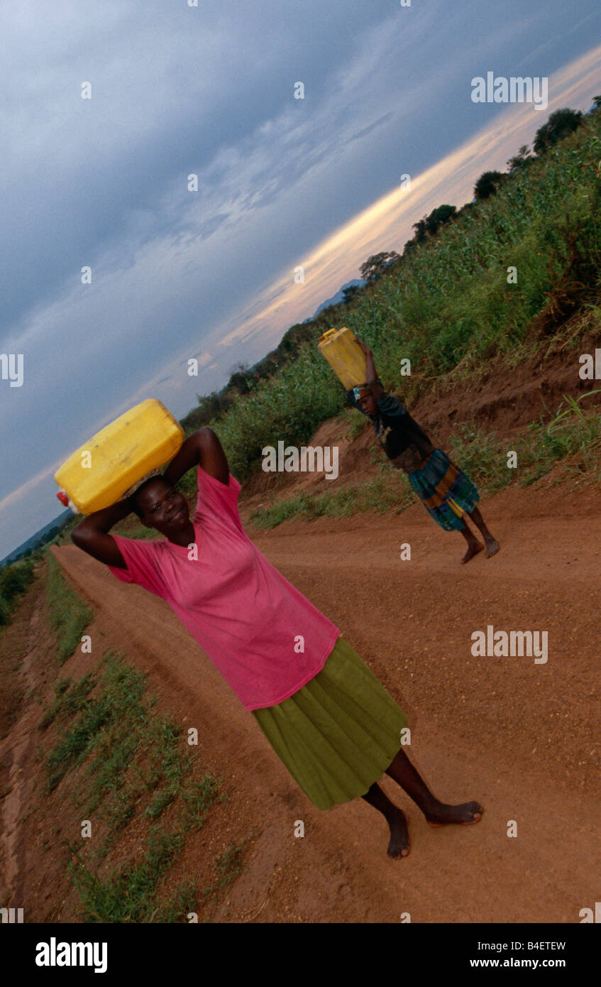 Villagers going to collect water in Uganda Stock Photo - Alamy