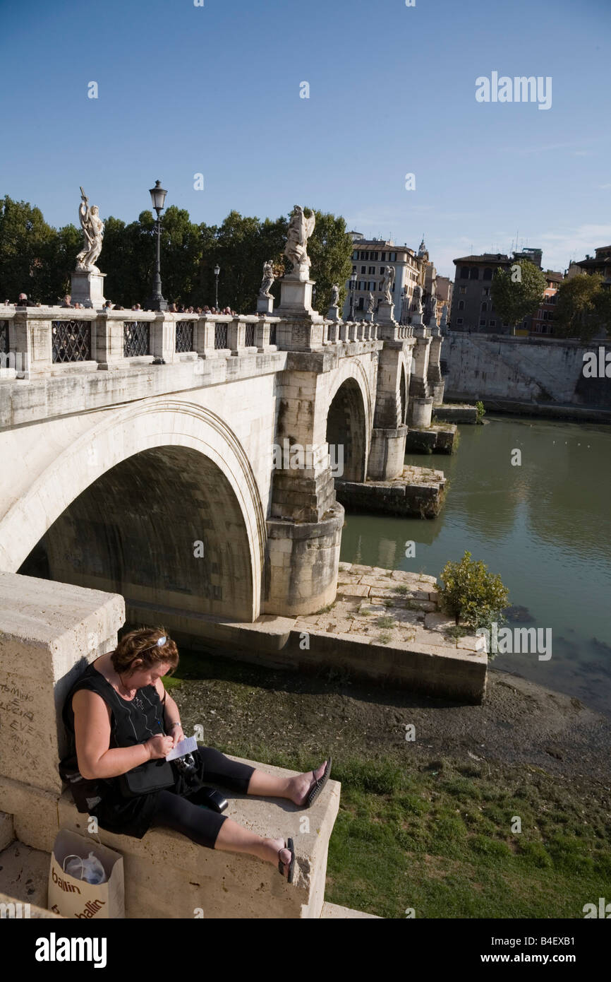 Lady writing notes on the Ponte Sant Angelo Rome Italy Stock Photo - Alamy