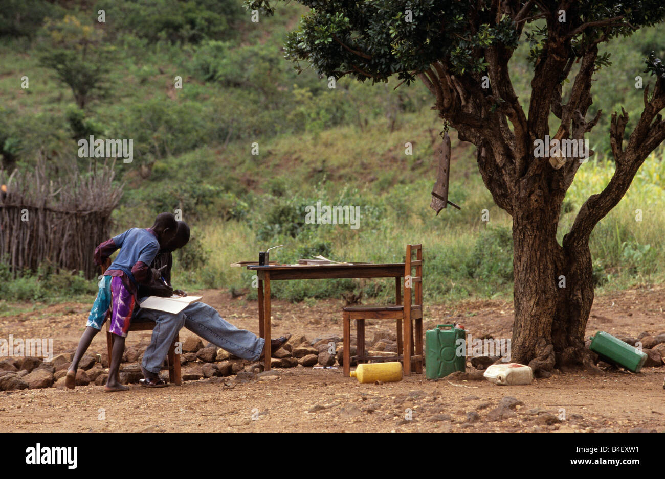 Teenage boys studying outdoors, rural scene, Mozambique, East Africa ...