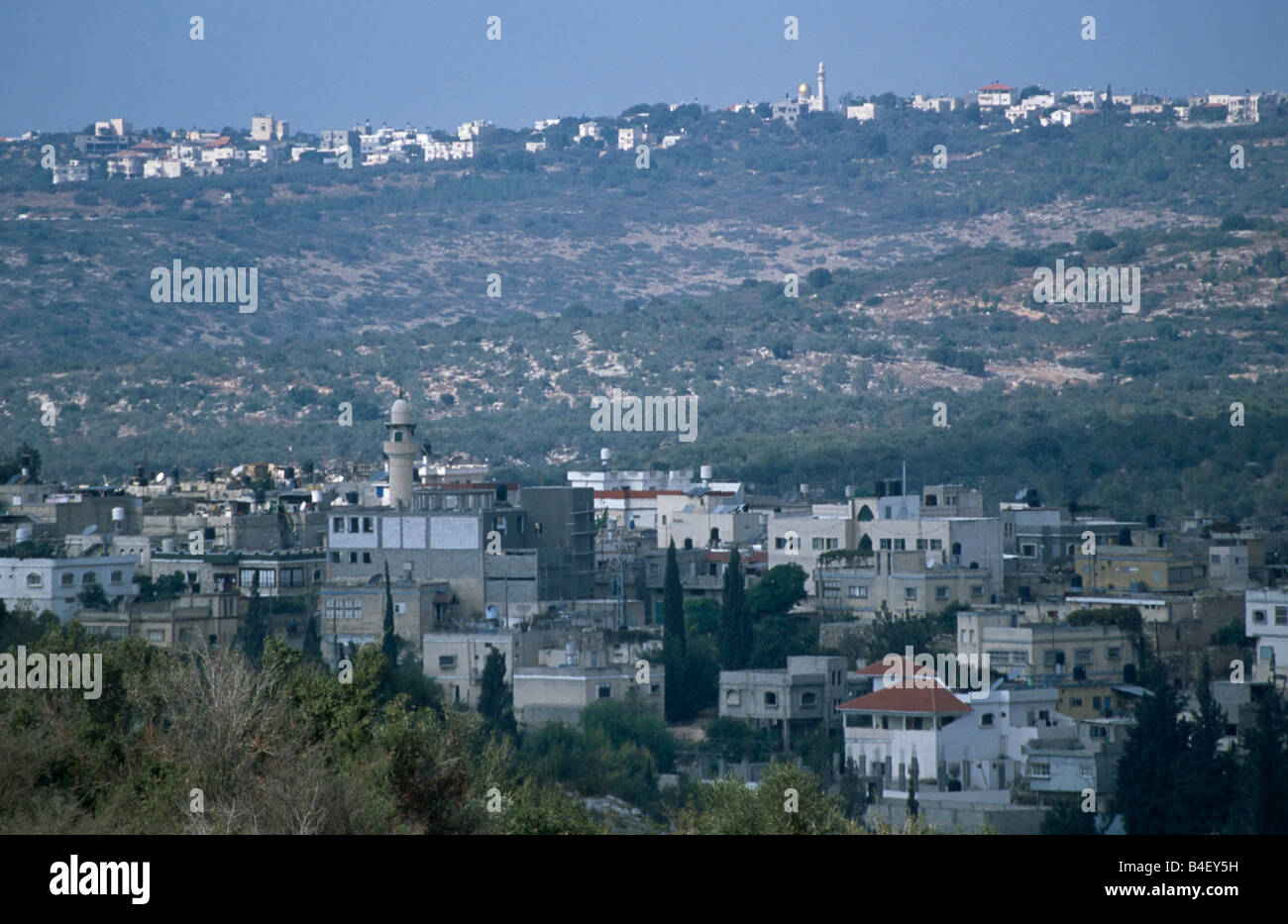 A village in Palestine with an Israeli settlement in the background ...