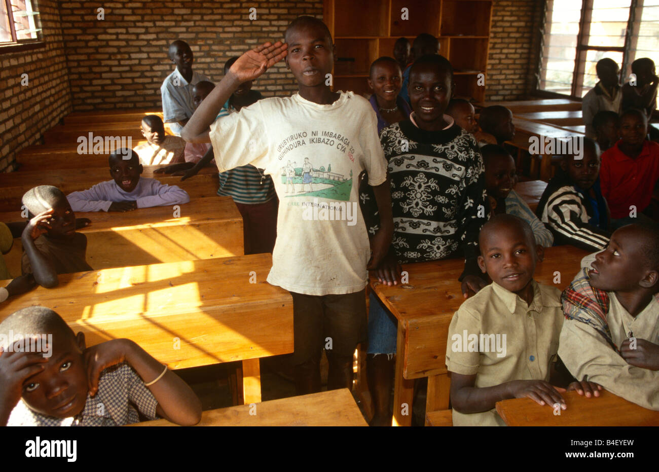 Boy saluting with classmates in classroom, Rwanda, East Africa Stock ...