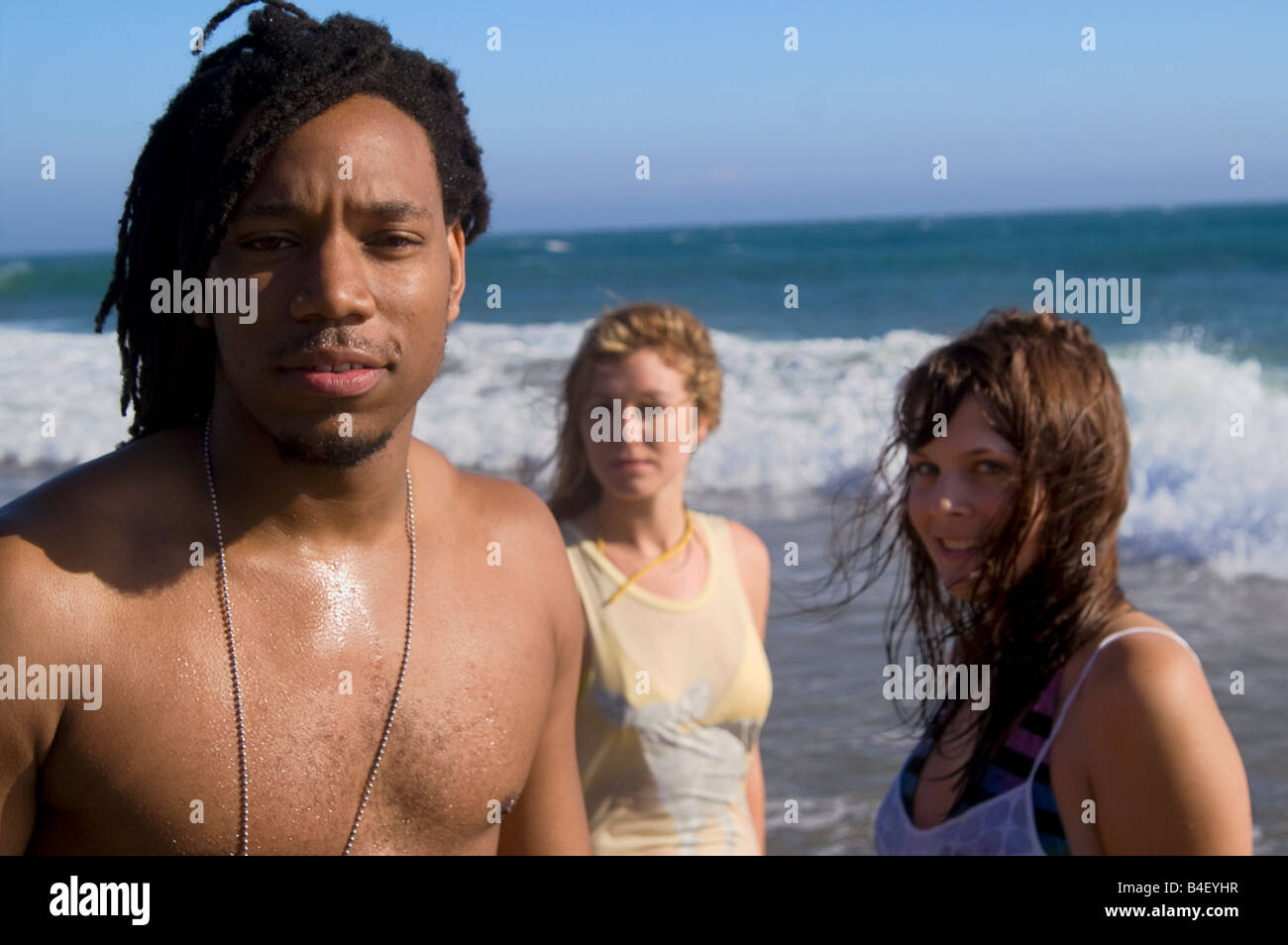Three People at the beach Stock Photo - Alamy