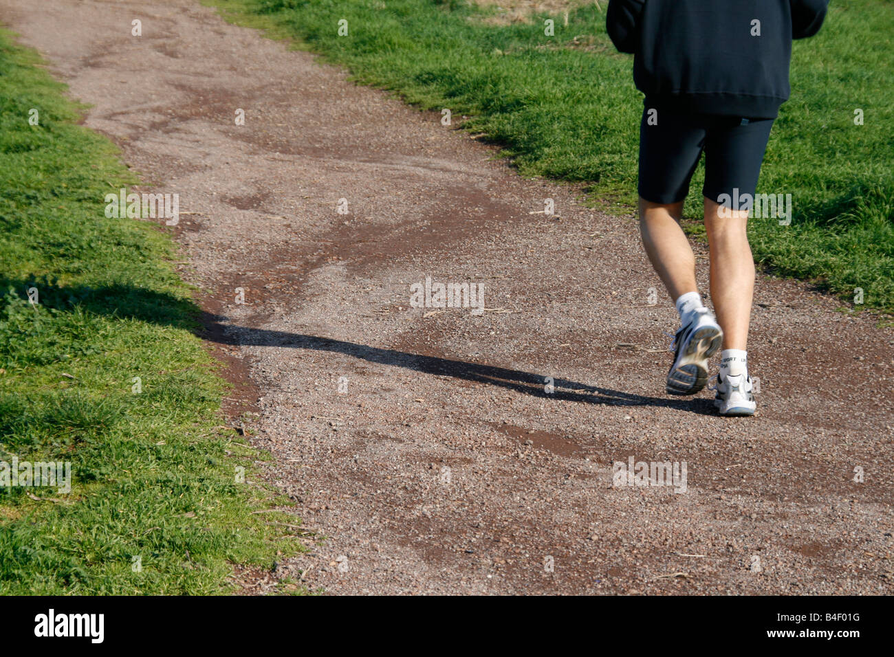 one single person jogging on path in park Stock Photo - Alamy