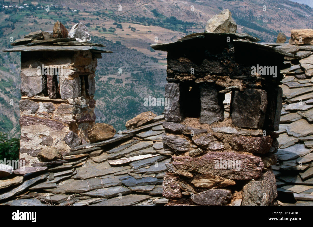 Traditional house roof with slate tiles and stone chimney stacks, Kukes ...