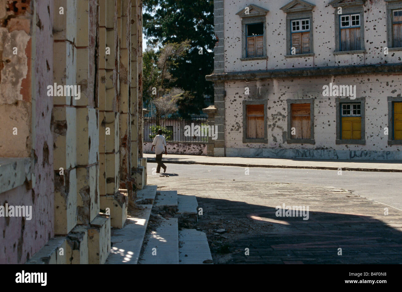 Civil war aftermath street scene with building facades scarred by ...