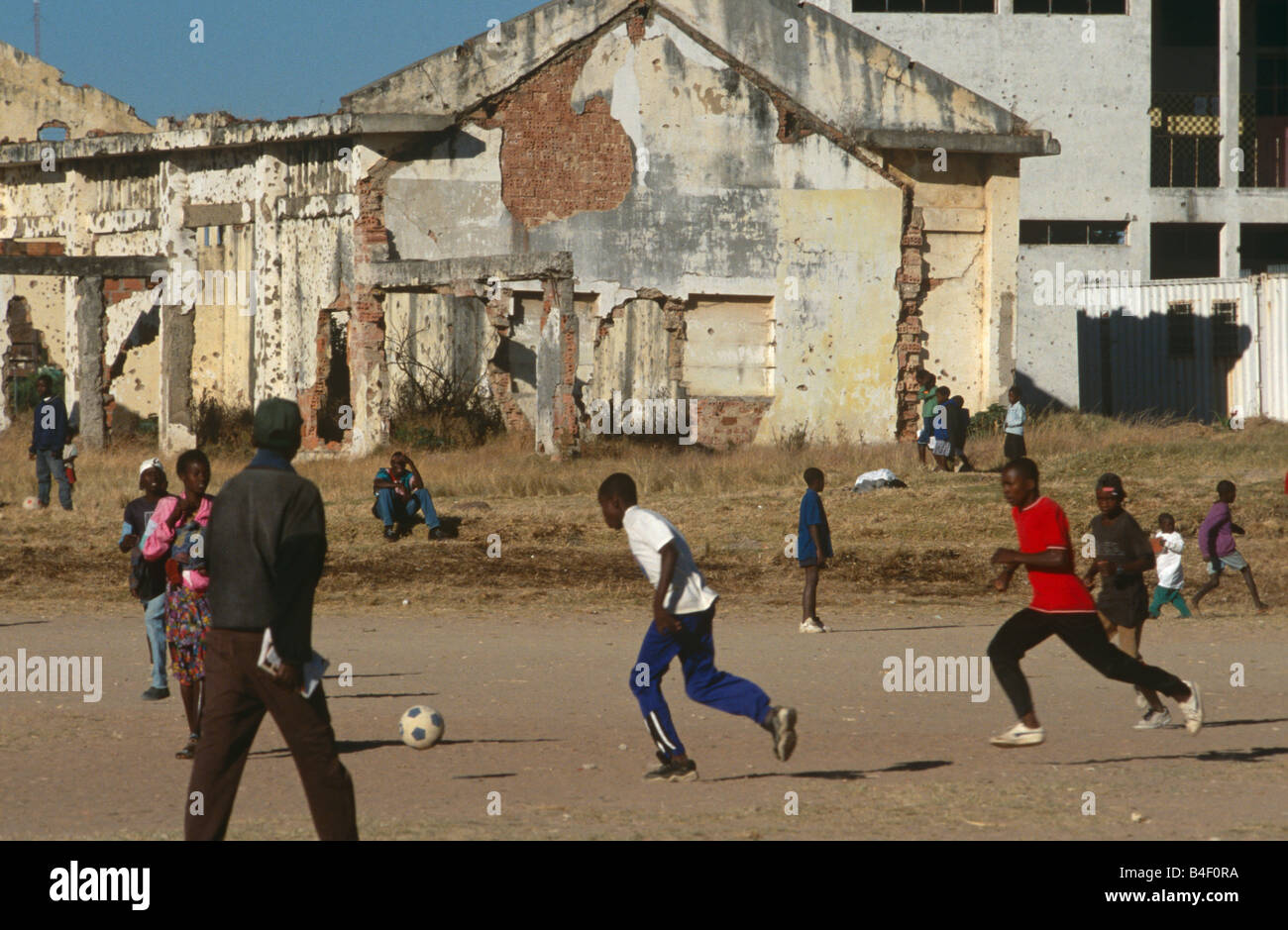 Civil war aftermath street scene with boy climbing on apartment window ...