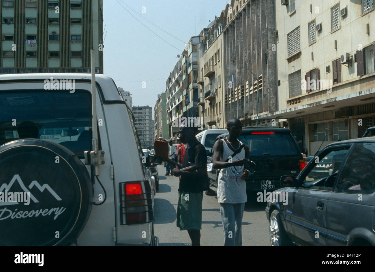 Street vendors selling to passing traffic on a street in Luanda, Angola ...