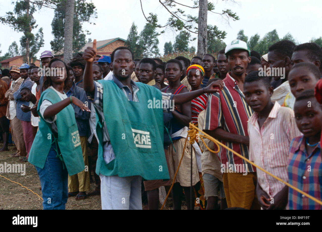 Workers from the NGO CARE supervising a food distribution in Burundi ...
