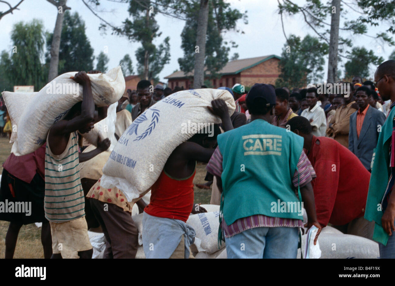 Workers from NGO CARE supervising food distribution, Burundi Stock ...