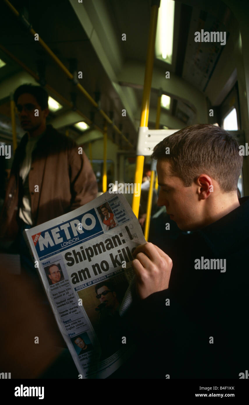 Man reading newspaper inside train, London, England, UK Stock Photo - Alamy