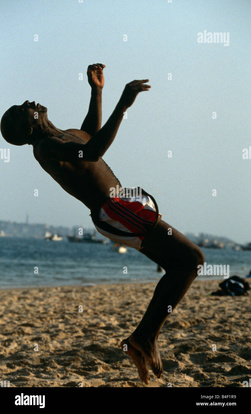 Man doing backflip on beach, Luanda, Angola Stock Photo - Alamy