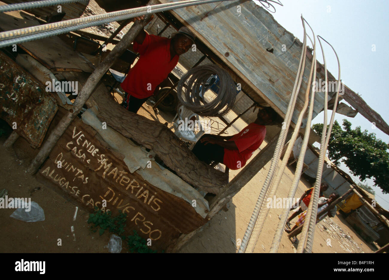 Vendor selling and renting various materials at roadside stall, Angola ...