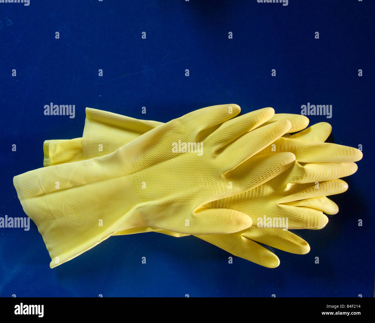 Two pairs of rubber gloves on top of each other Stock Photo - Alamy