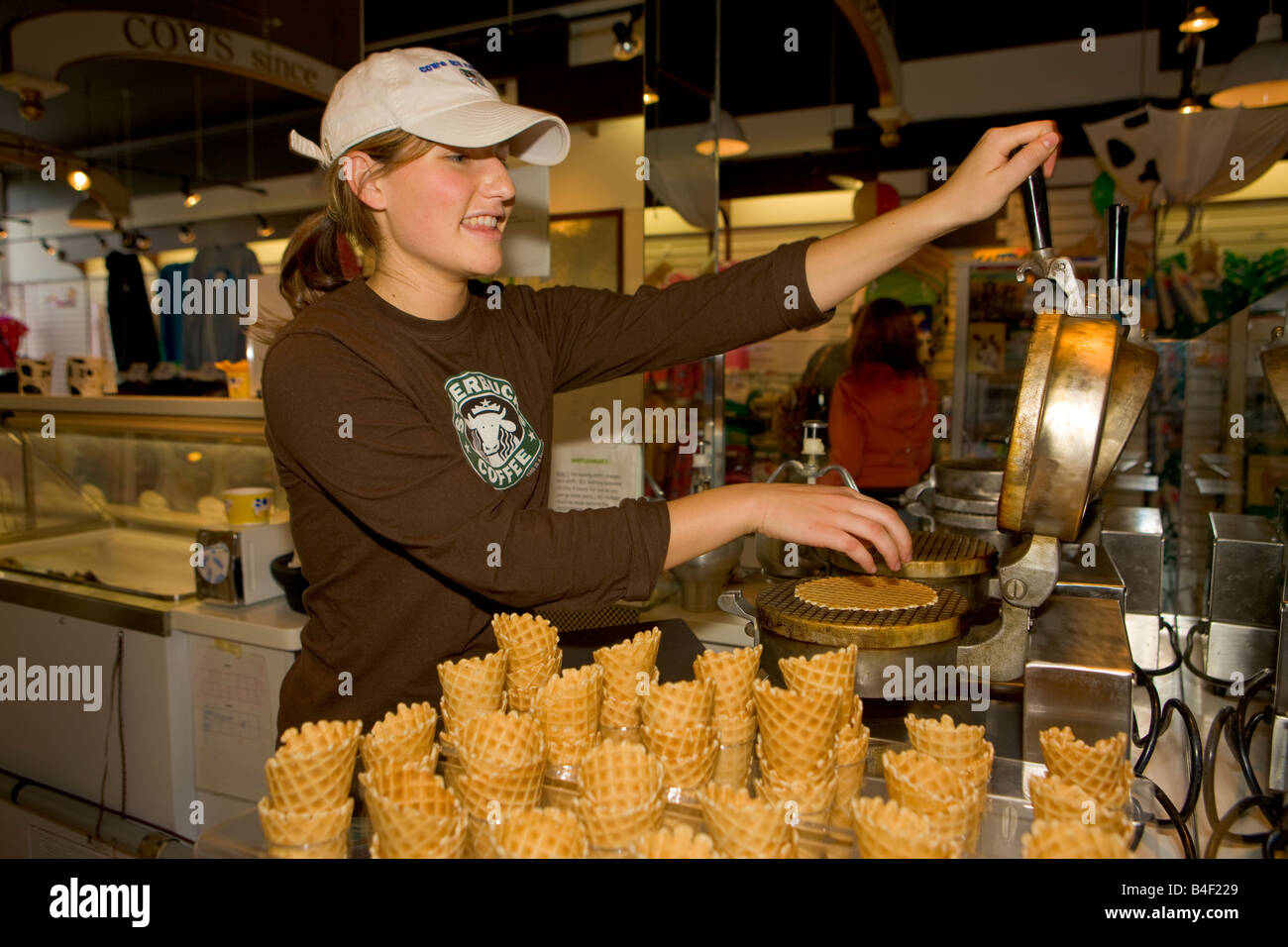 Woman making waffle cones at a store (Cow's) in the town of Niagara-on ...