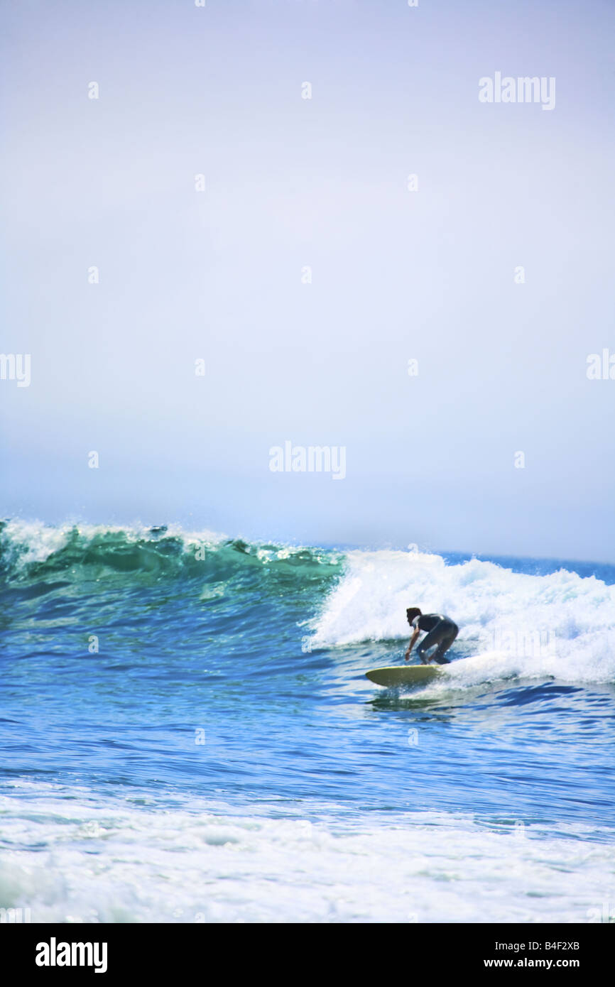 A Southern California surfer rides the ocean waves in the day Stock ...