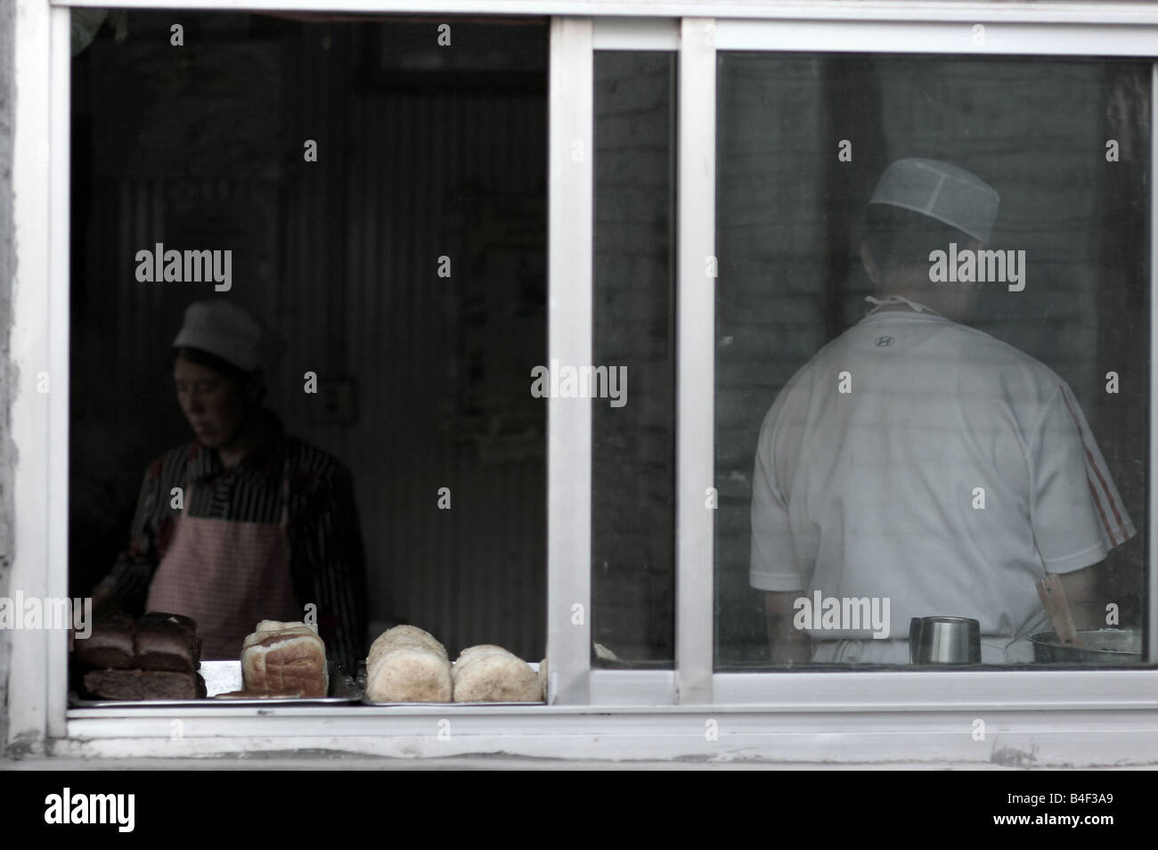 Chefs cooking in a restaurant in a hutong in Beijing, China Stock Photo ...