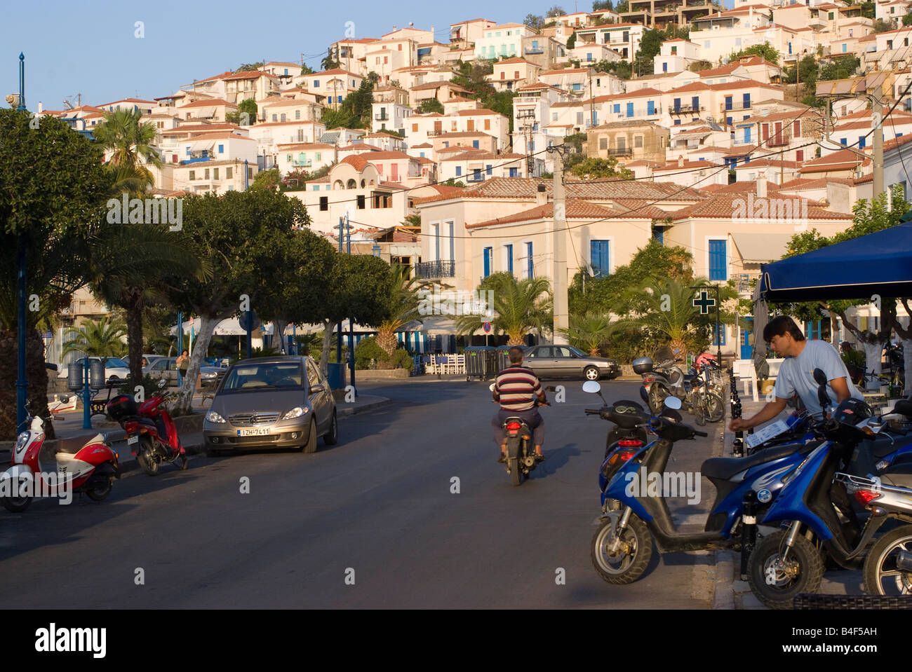 Waterfront Street in Lovely Poros Town with Housing in Terraces Behind ...