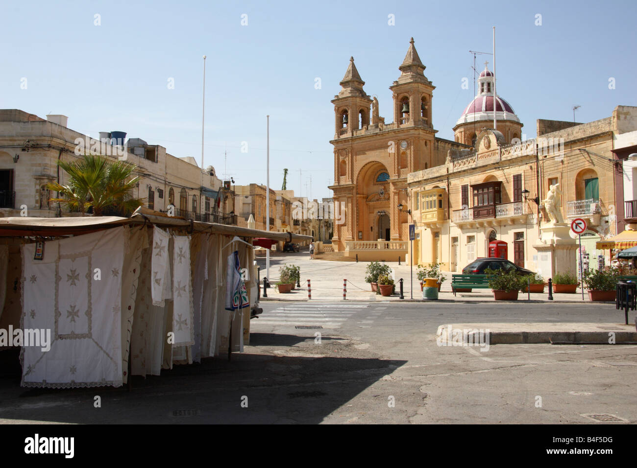 Market Stalls and church next to the harbour in Marsaxlokk village ...