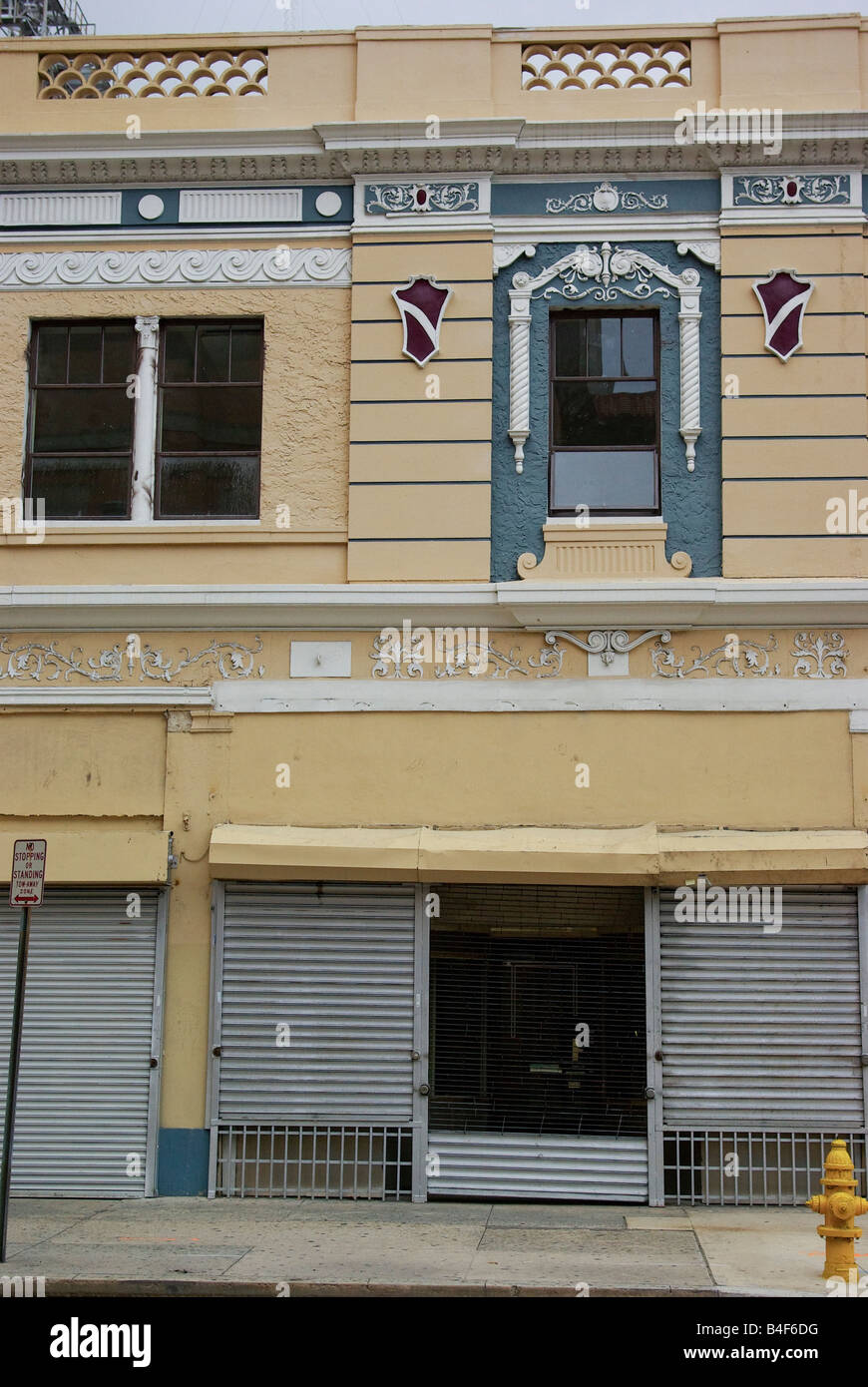 Metal shutters cover an unused storefront in Miami, Florida Stock Photo ...