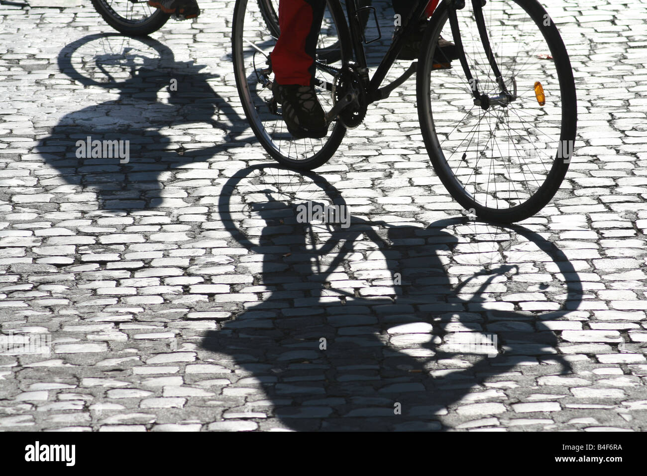 shadow two bikes in action in sun in street in rome Stock Photo - Alamy