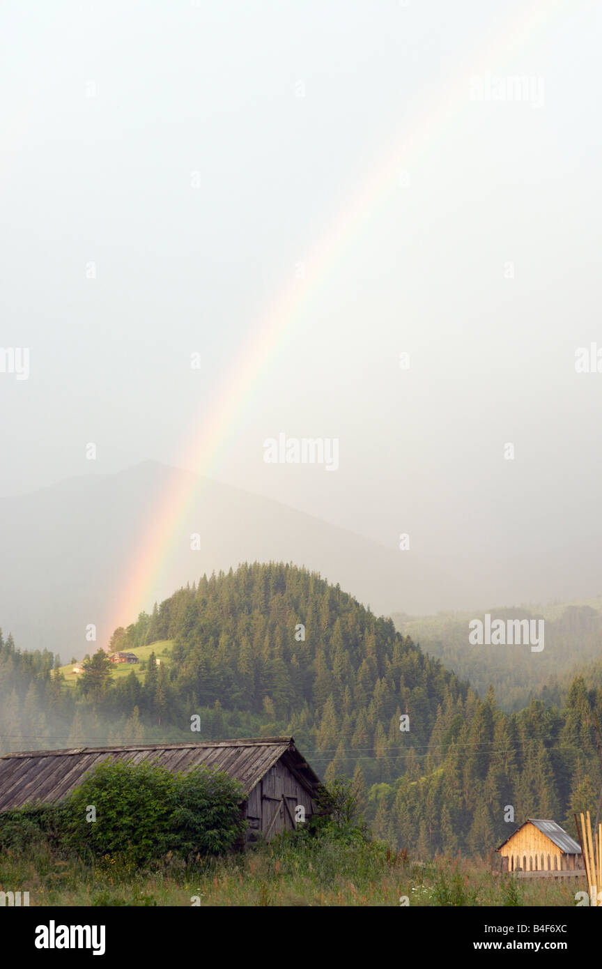 rainbow over mountain village after the rain Stock Photo - Alamy