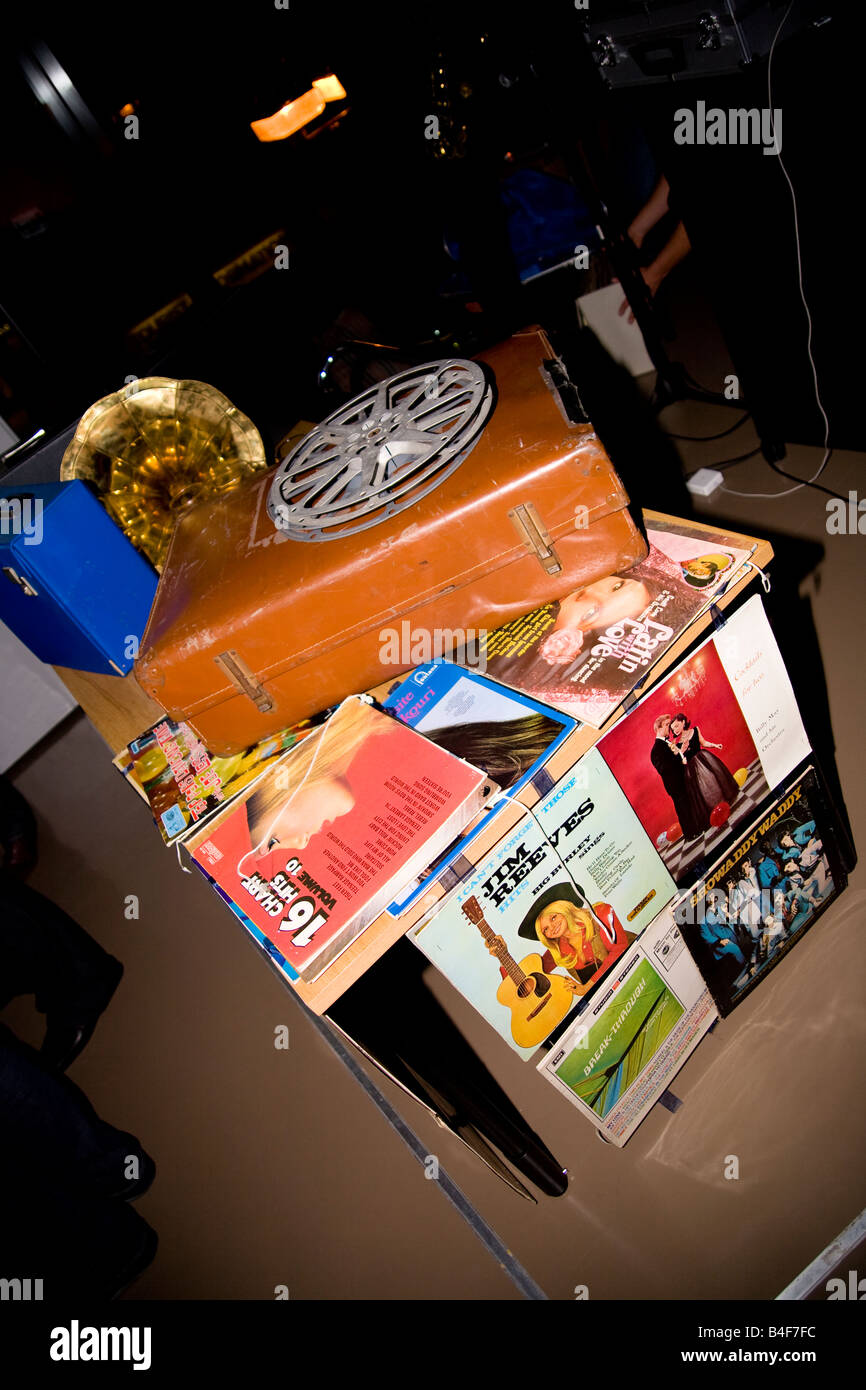 A display of vintage and retro vinyl records, suitcase and film reel ...