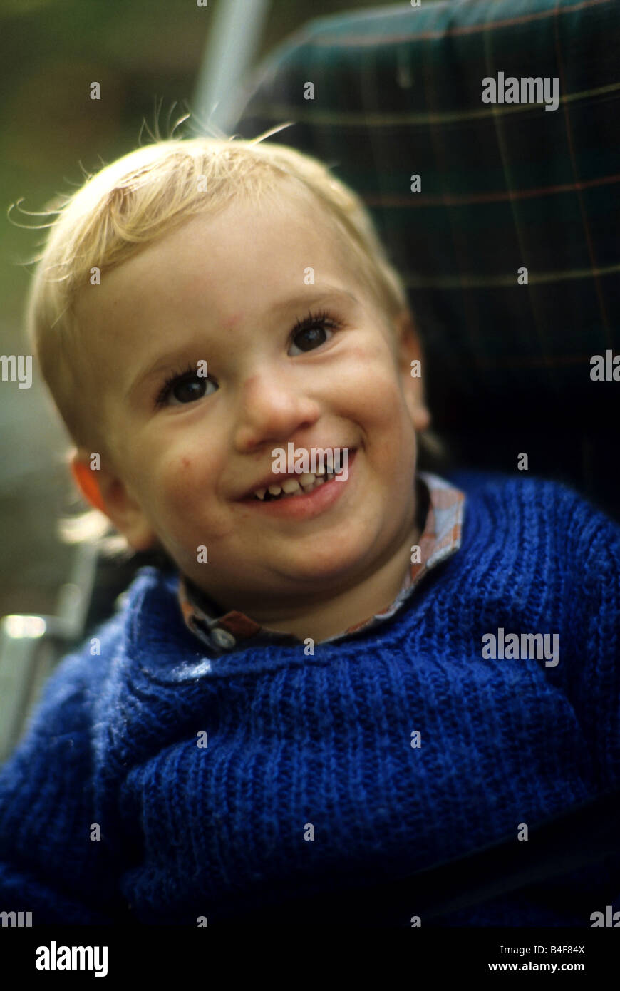 Face of a little boy laughing in his pram Stock Photo - Alamy