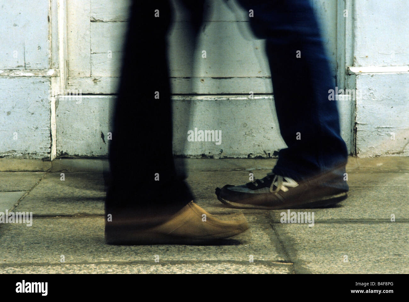 Feet of two people crossing in the street Stock Photo - Alamy