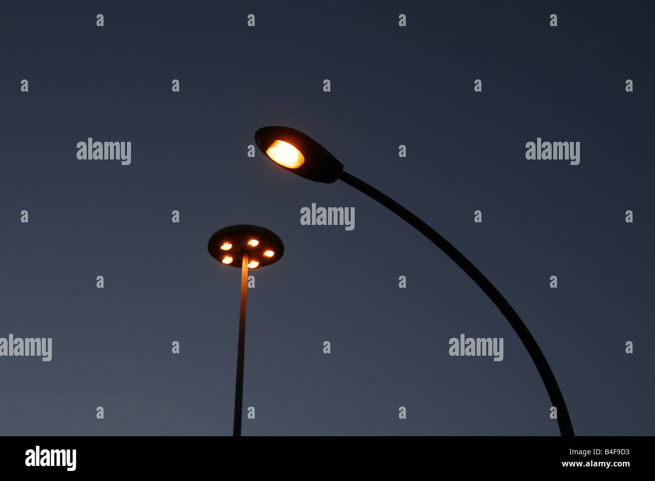 modern lamp posts in city street at night Stock Photo - Alamy