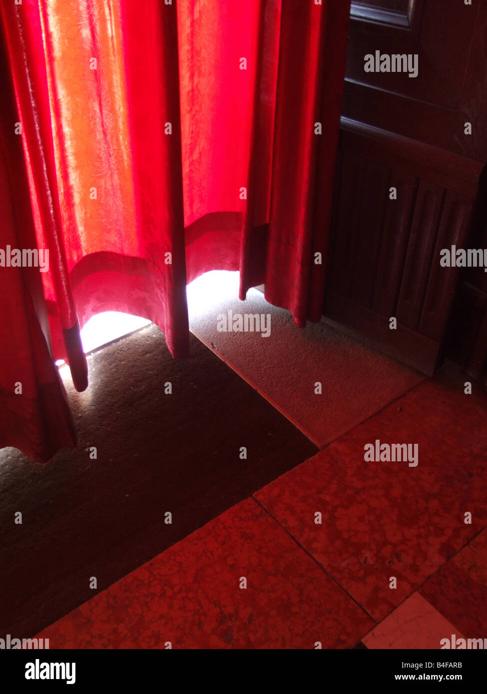long red curtains in church door entrance Stock Photo - Alamy