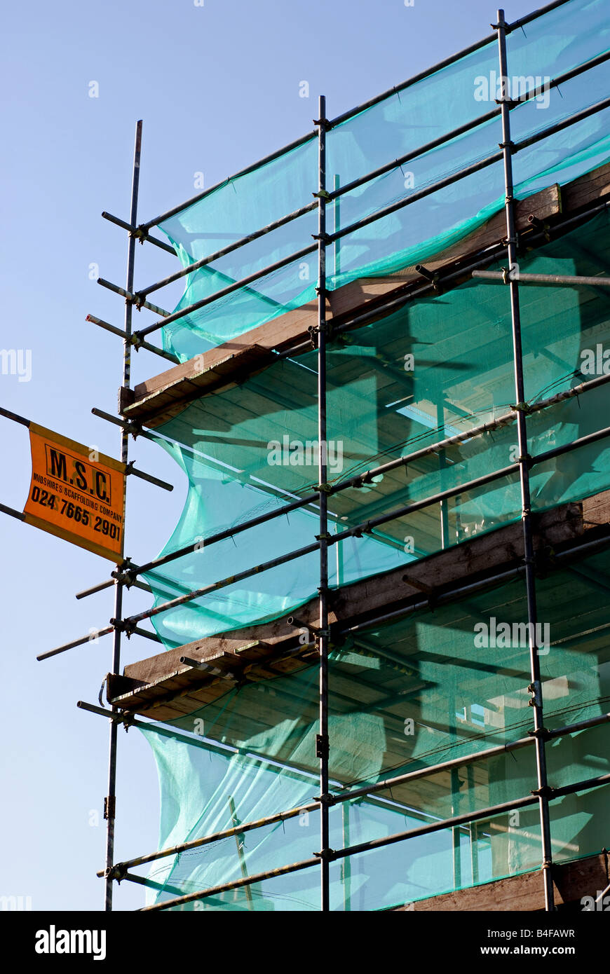Scaffolding with green mesh on building Warwick Warwickshire England UK ...