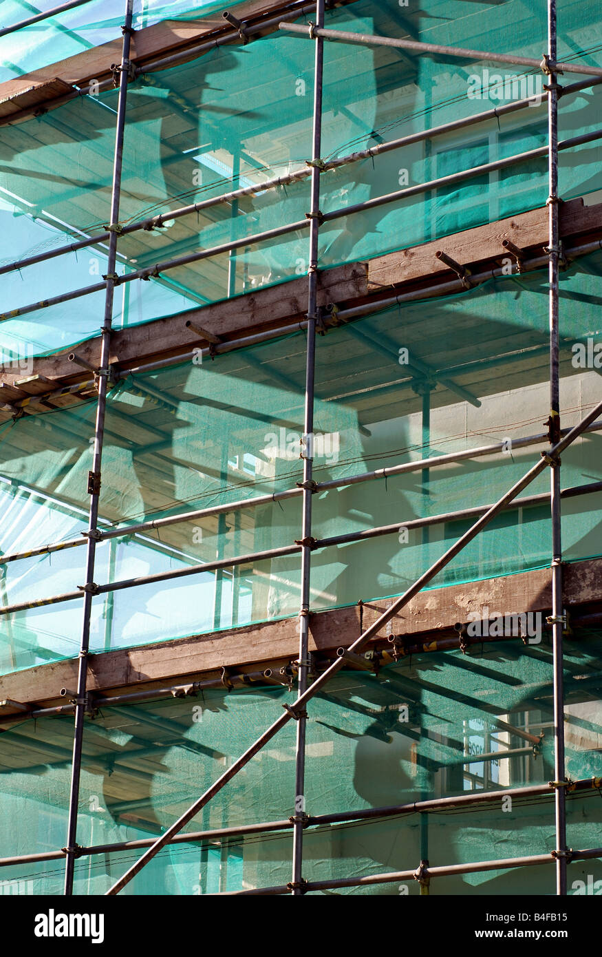 Scaffolding with green mesh on building Warwick Warwickshire England UK ...