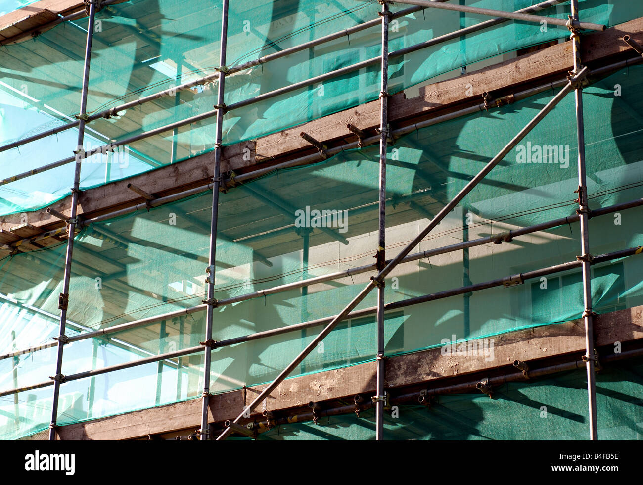 Scaffolding with green mesh on building Warwick Warwickshire England UK ...