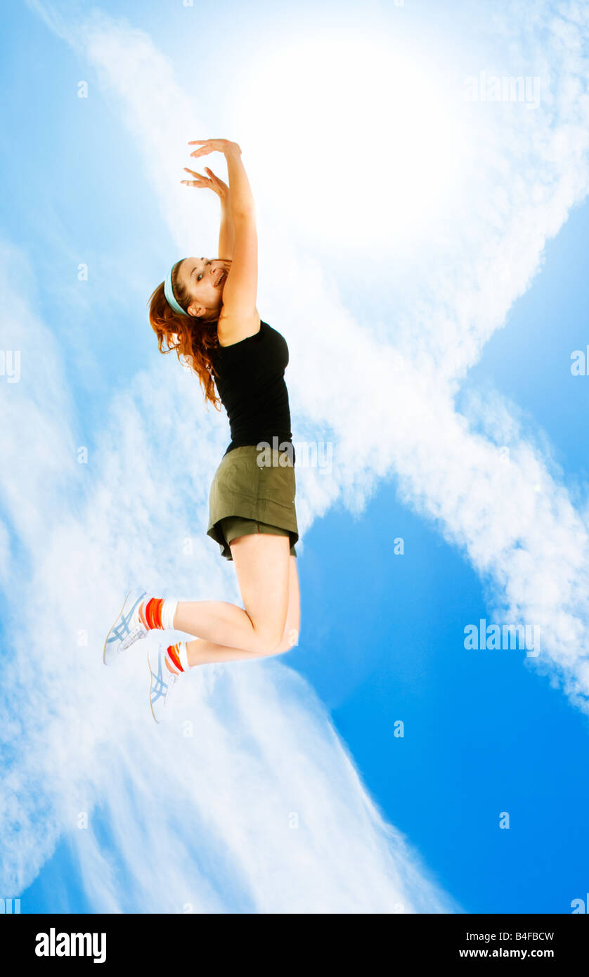 Happy jumping woman against the blue sky Stock Photo - Alamy
