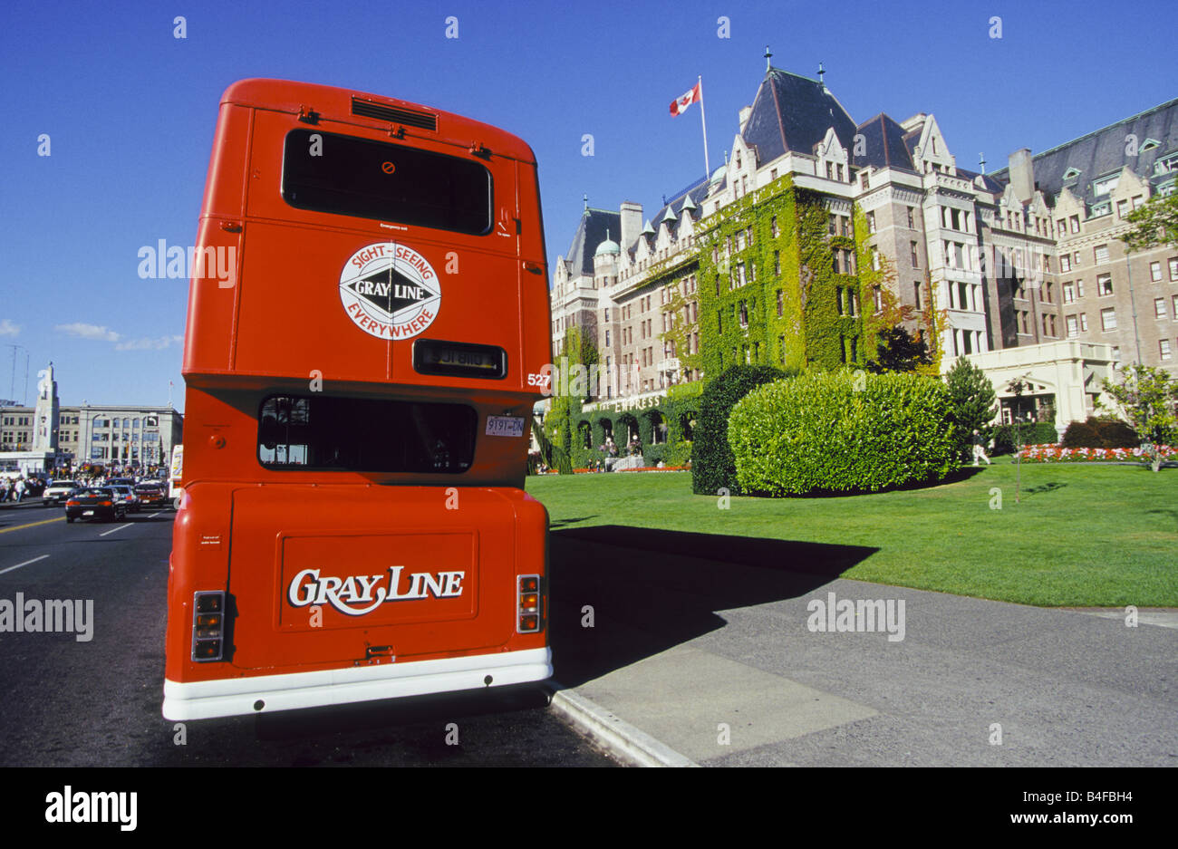 A double decker red tour bus in front of the Empress Hotel on Victoria ...