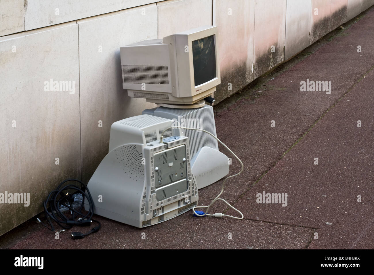 Three old obsolete computer screen monitors discarded as junk on the ...