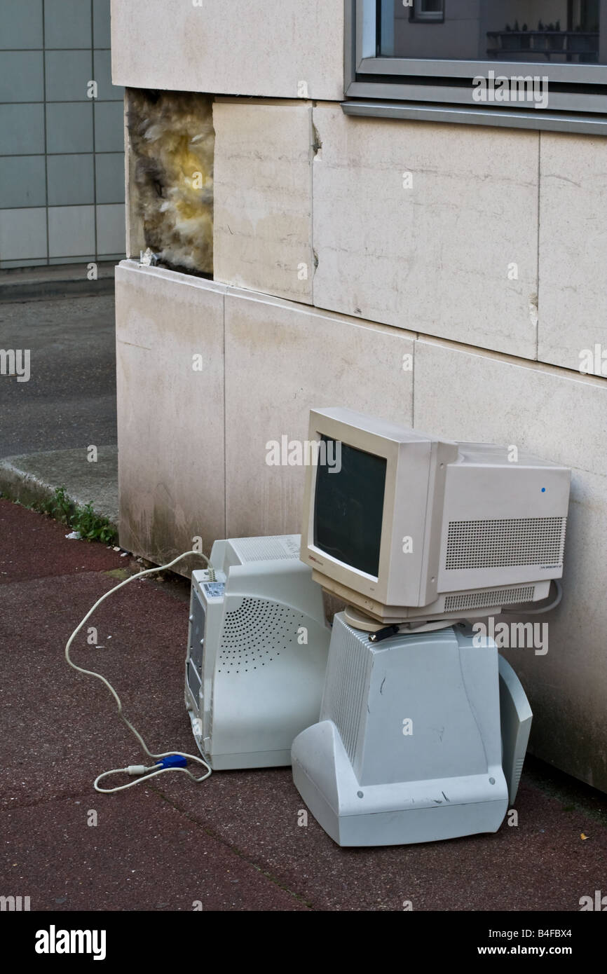 Three old obsolete computer screen monitors discarded as junk on the ...