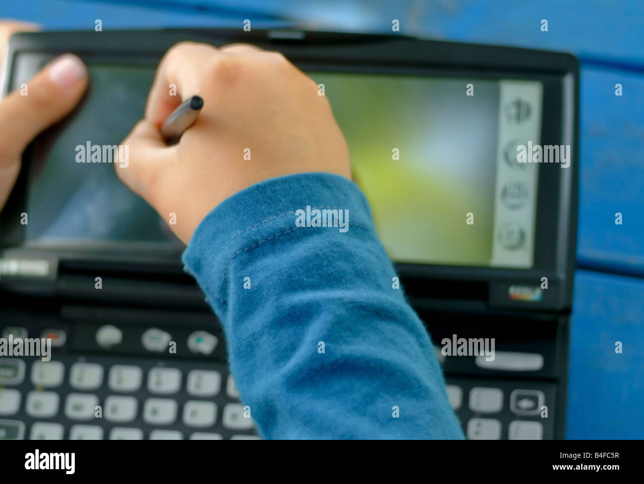 child writing an typing on a PDA Stock Photo - Alamy