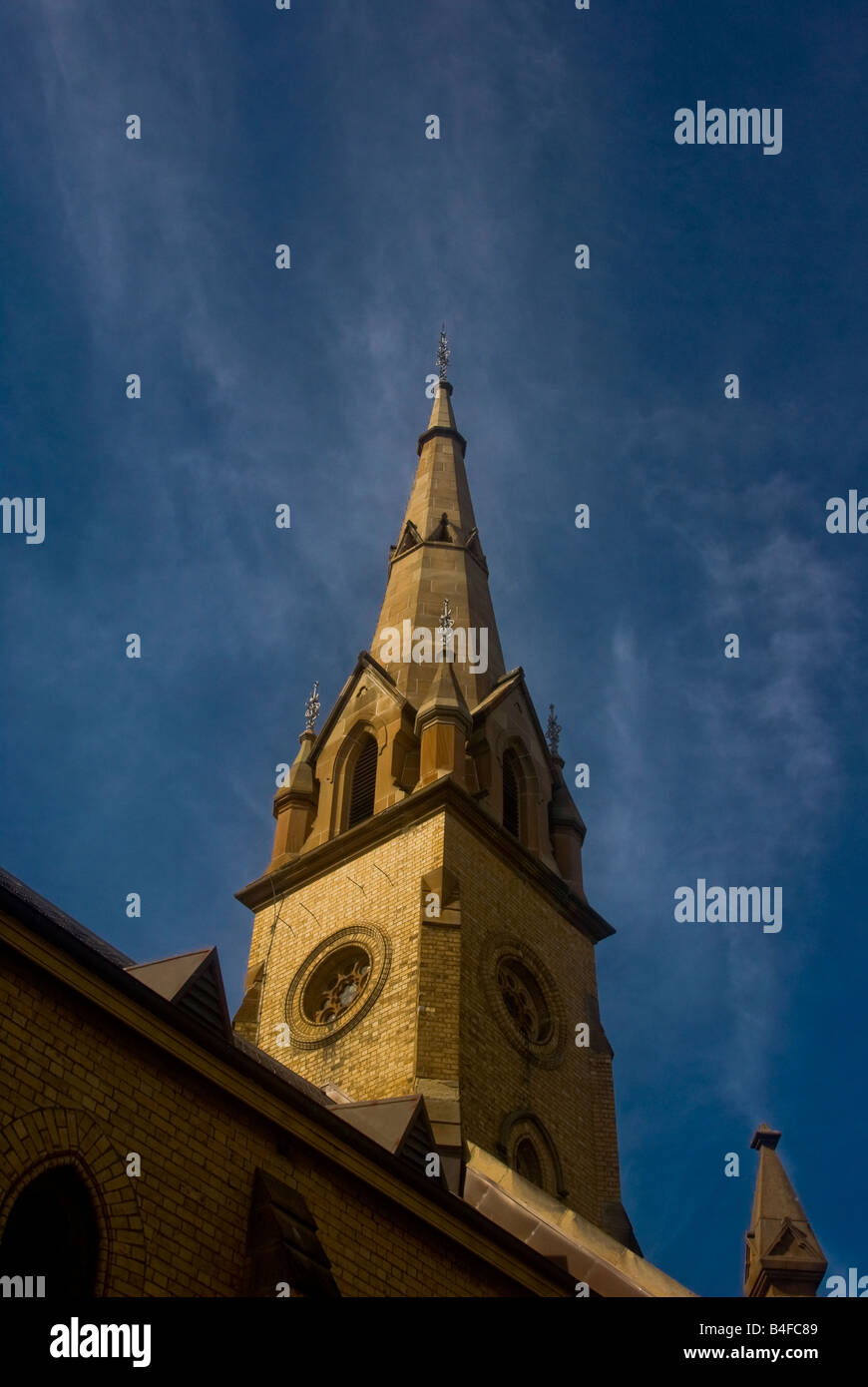 The spire of a classic sandstone church point to heaven like a giant ...