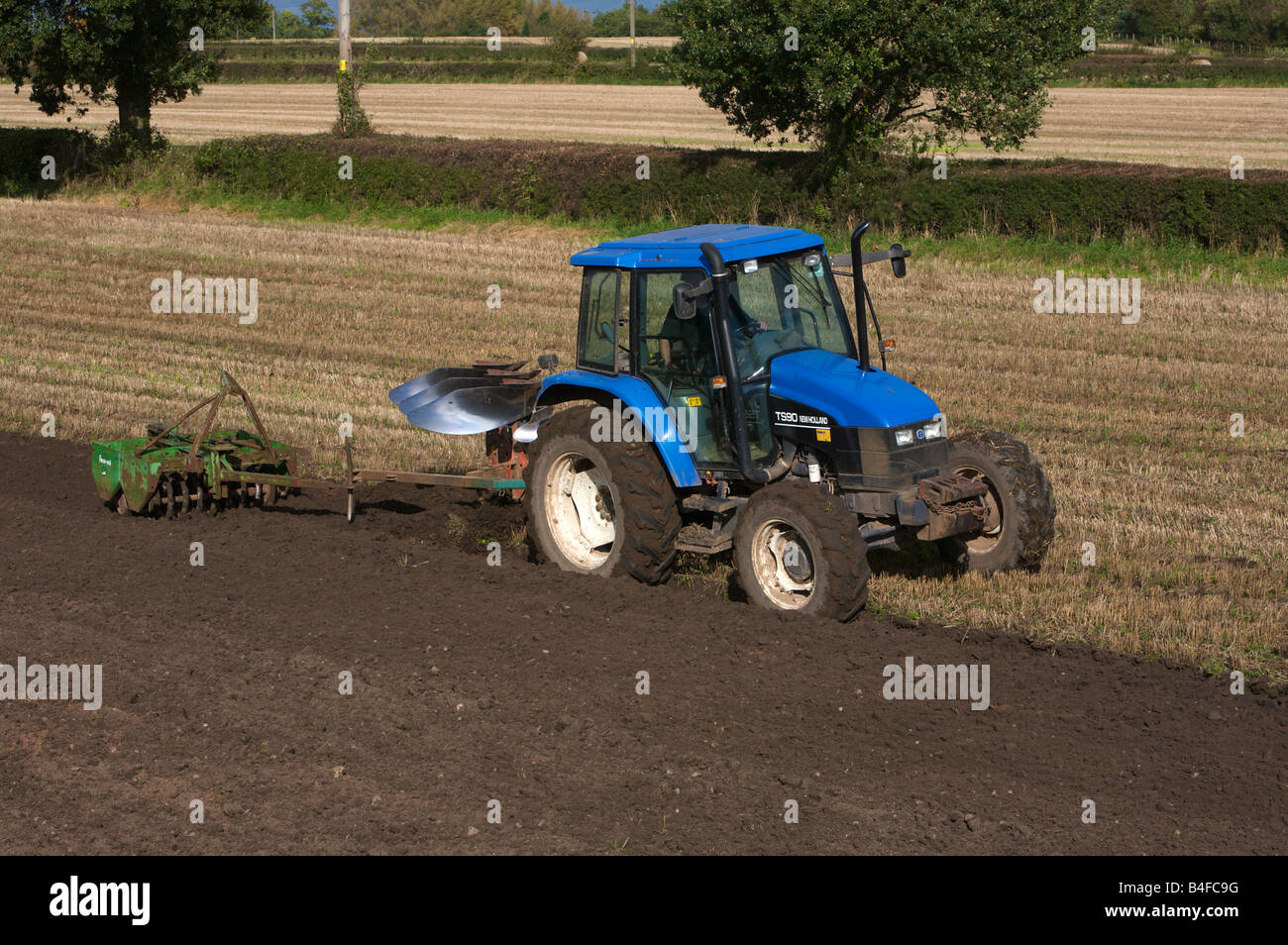 Ploughing up a stubble field ready to plant Barley with a New Holland ...