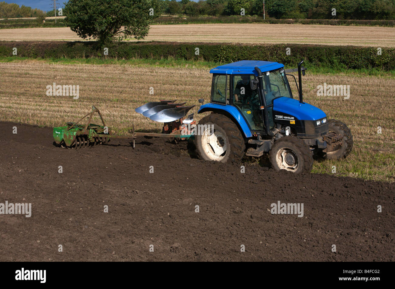 Ploughing up a stubble field ready to plant Barley with a New Holland ...