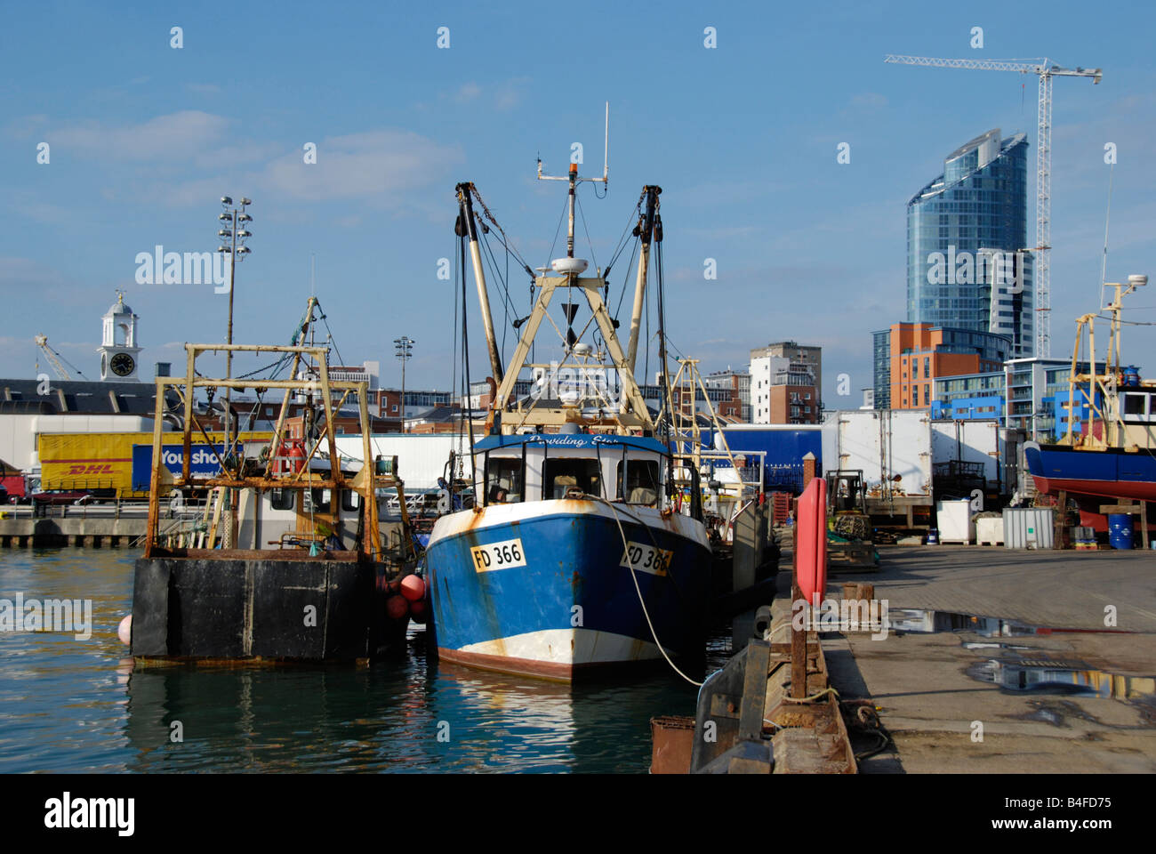Fishing boats in Camber Dock with Gunwharf Quays in the distance Old ...