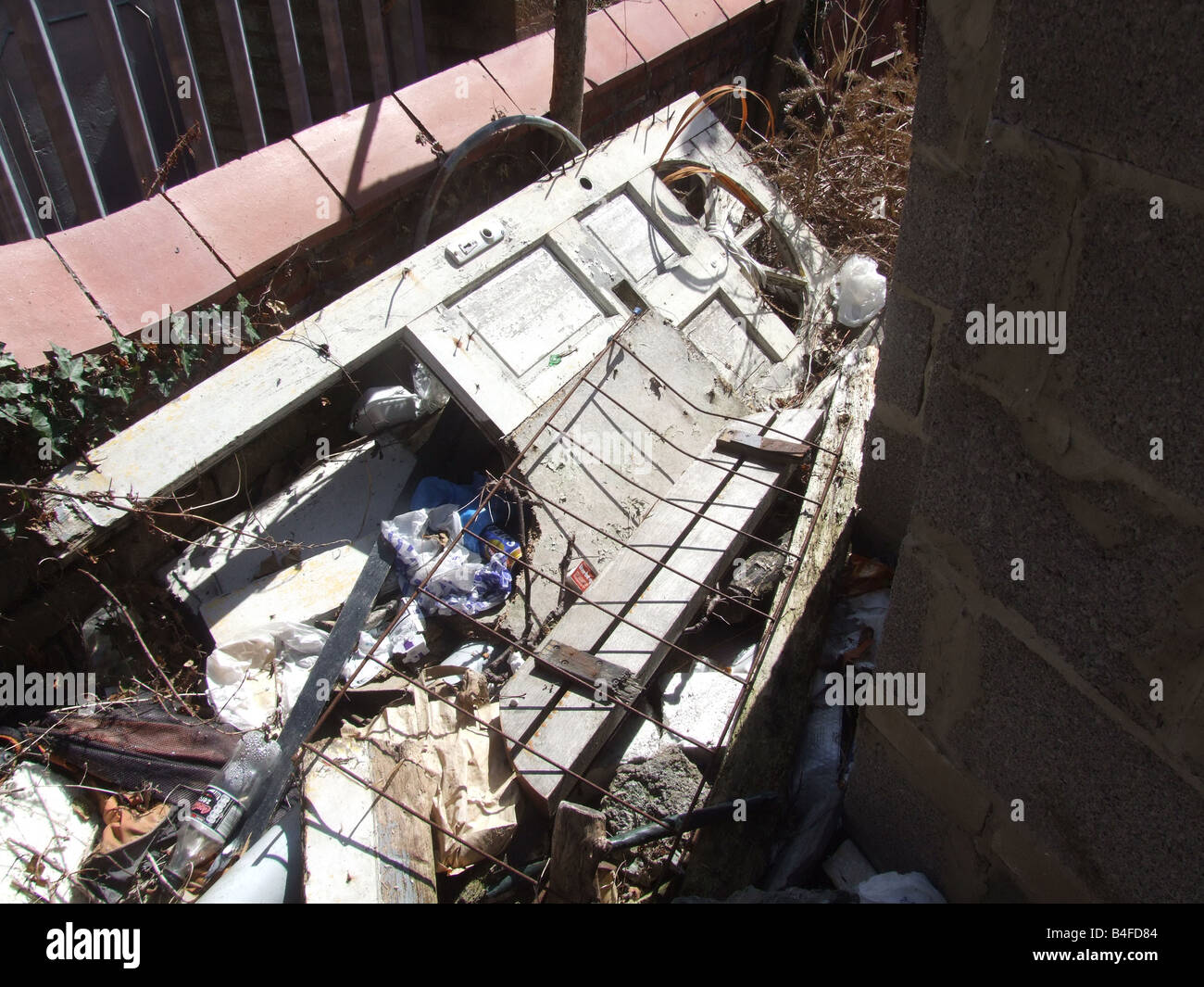 wooden door dumped on derelict ground Stock Photo - Alamy